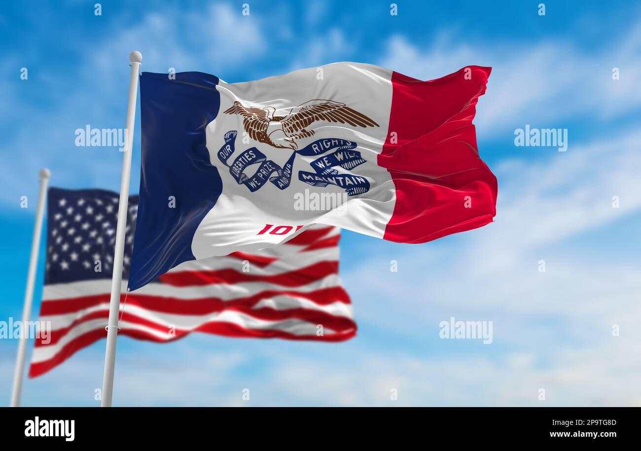 flag of Iowa state, Usa in front of official Flag of US at cloudy sky ...