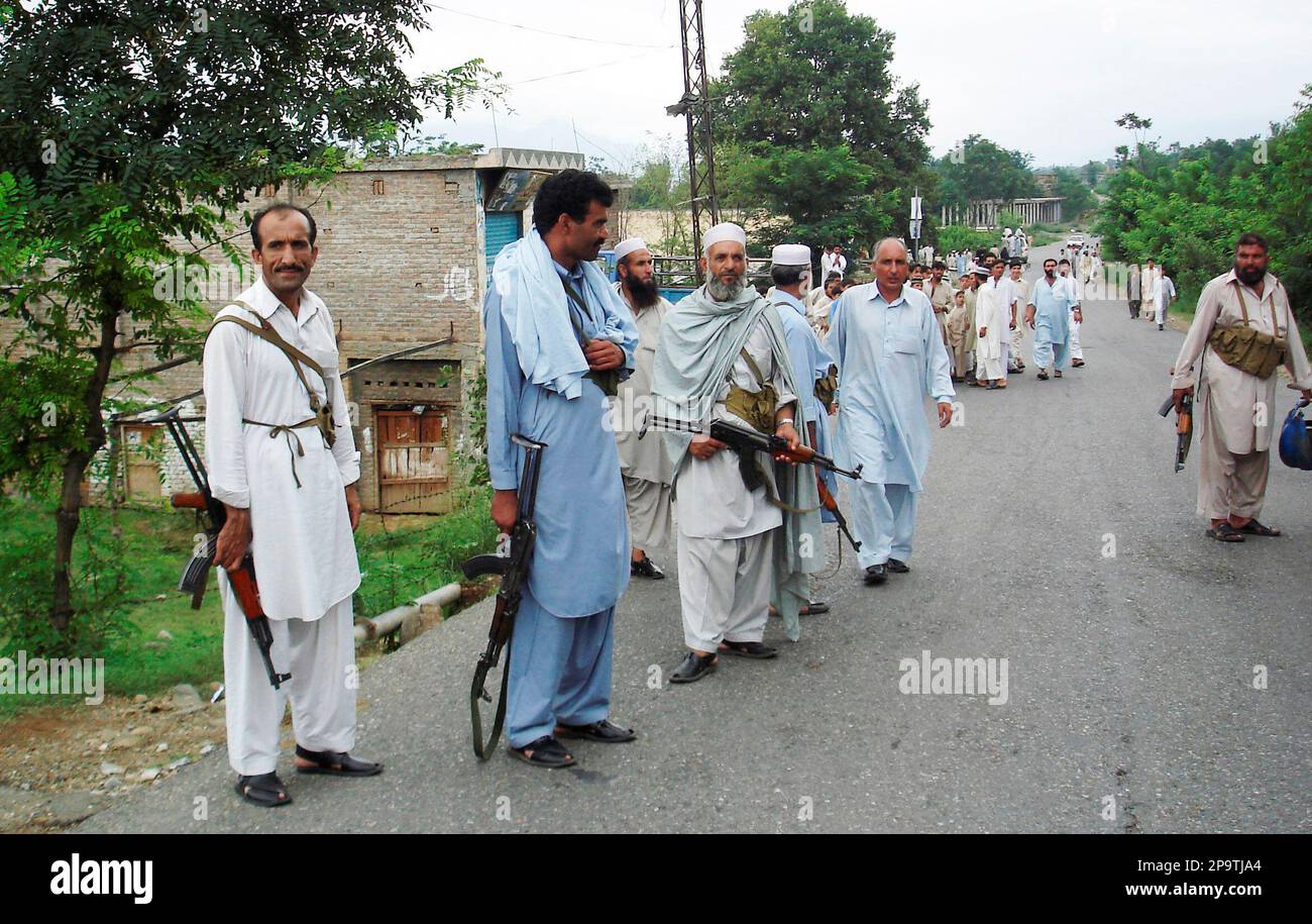 Pakistani police officers in plain clothes guard a main road in ...