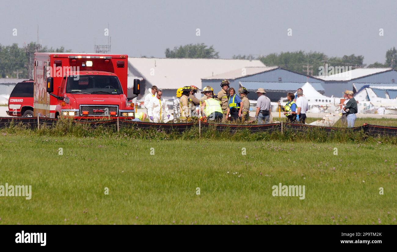 Rescue workers respond to a single engine plane that crashed on landing ...