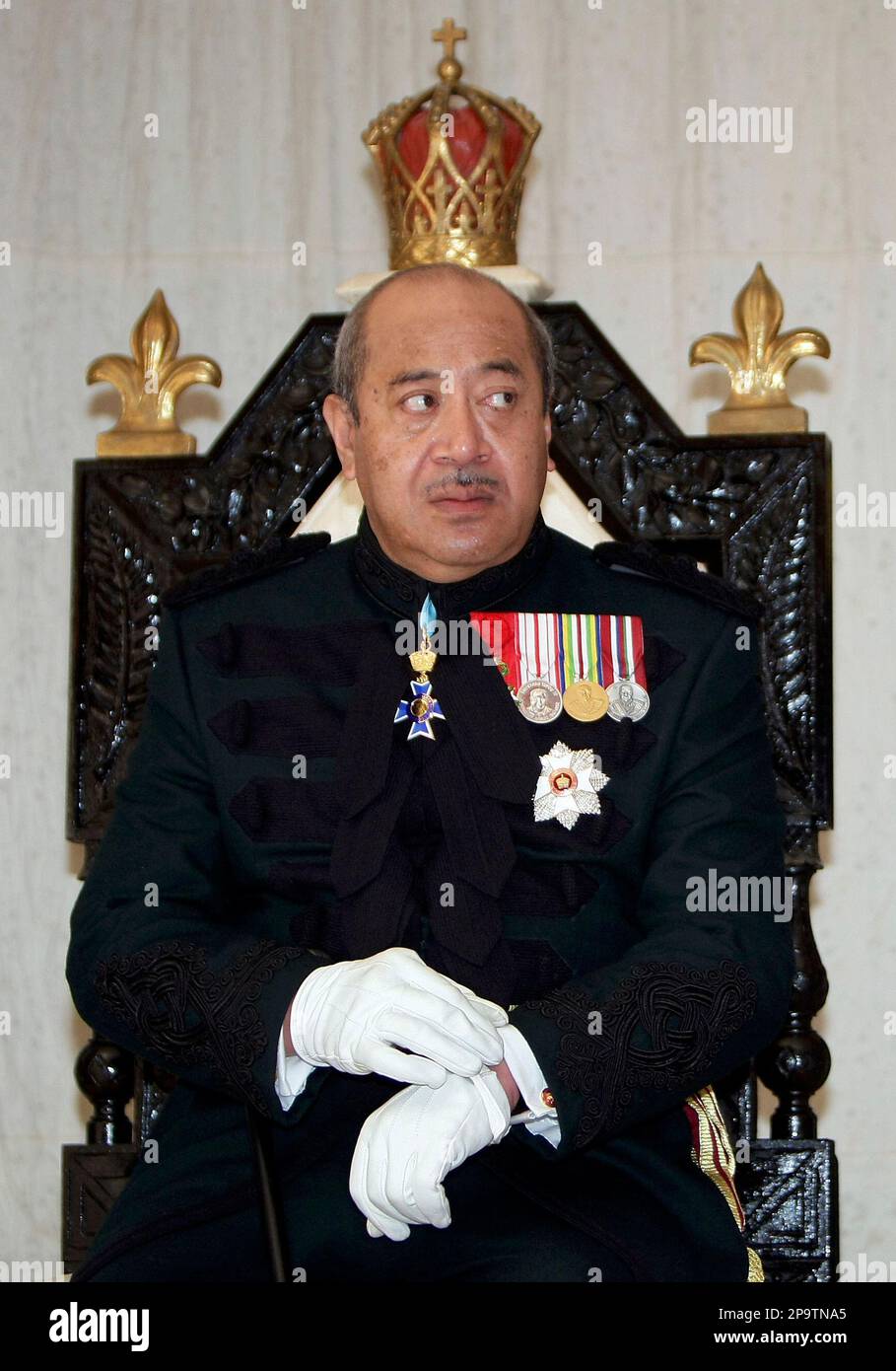 Tonga's new monarch, King George Tupou V, sits on his throne in the ...