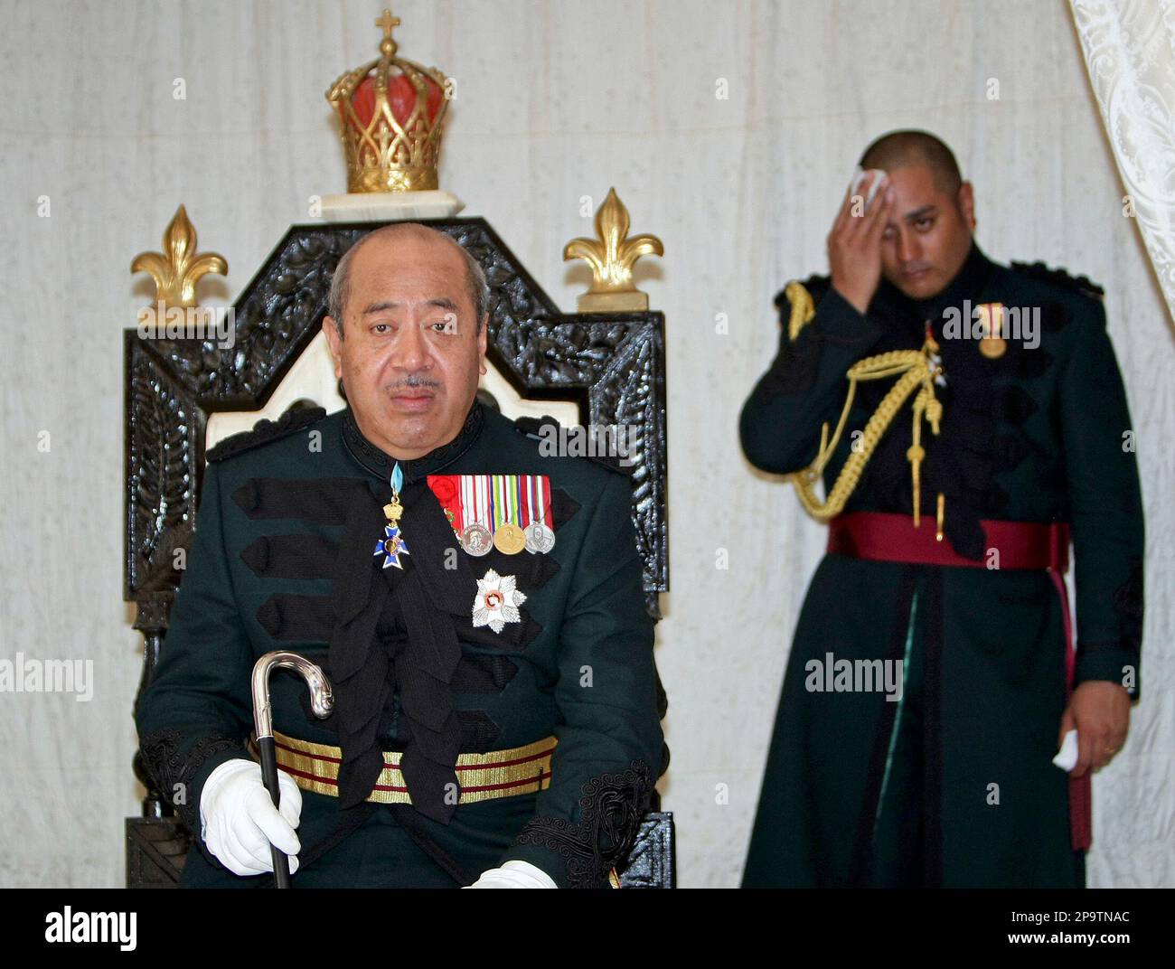 Tonga's new monarch, King George Tupou V, sits on his throne as aide-de ...