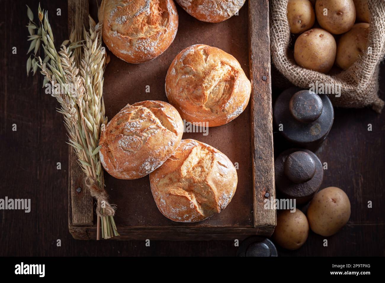 Tasty and fresh potato buns in rustic cellar. Potato buns of wheat and ...
