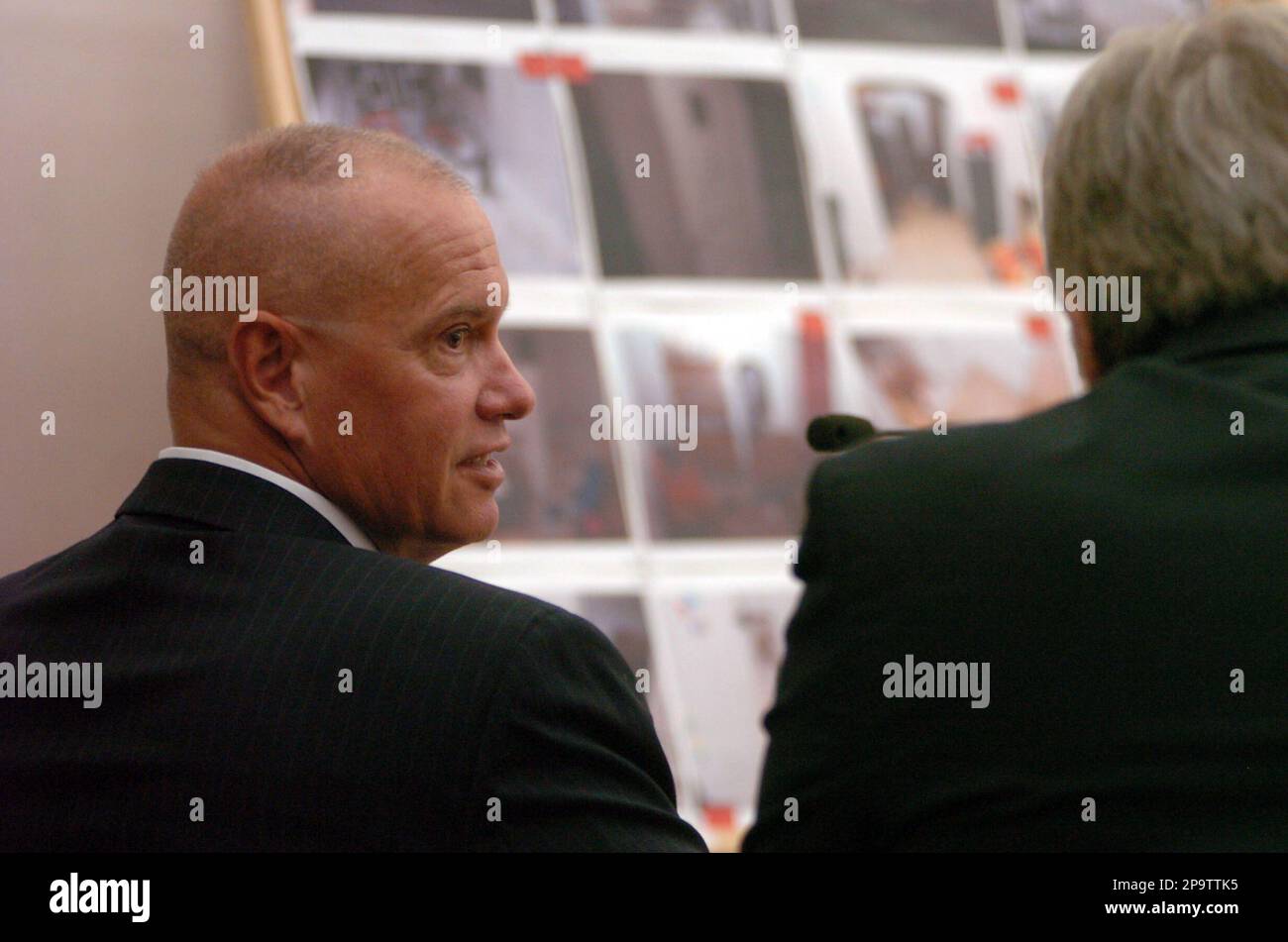 Sgt. Joe Chavalia and his attorney, William Kluge, look at photographs ...