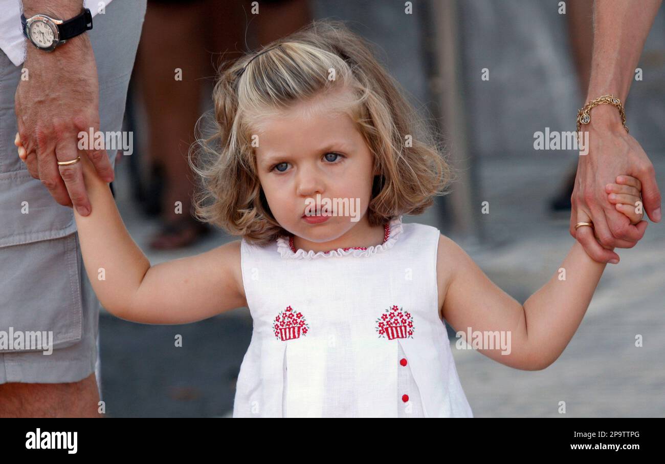 Princess Leonor holds hands with her father, Prince Felipe, left, and ...