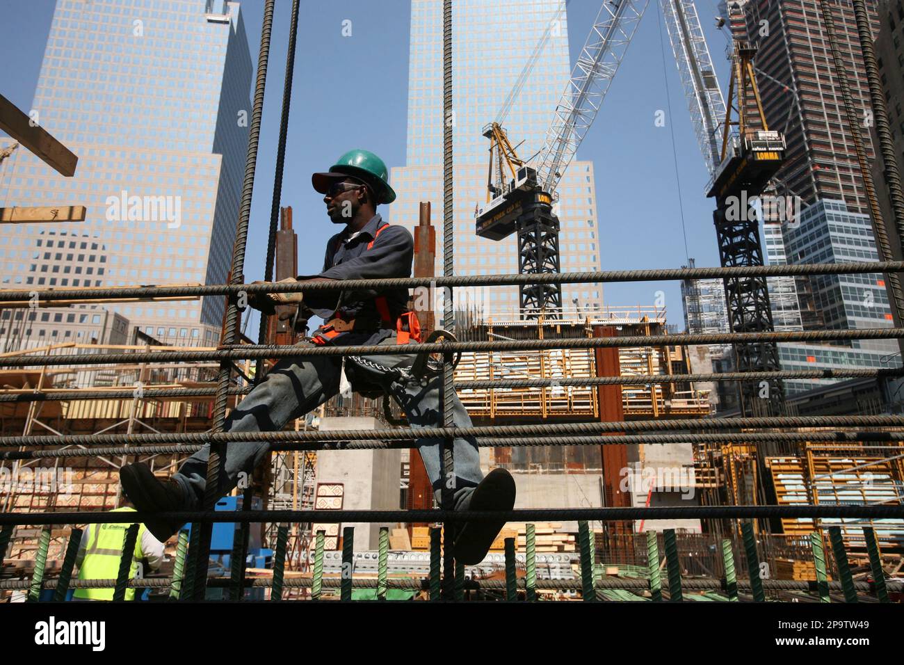 Ironworker Donald Sibbles works on a concrete and steel wall adjacent ...