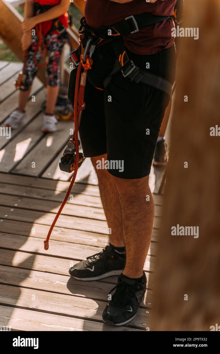 Details of a man standing with protectors on in the adventure park ...