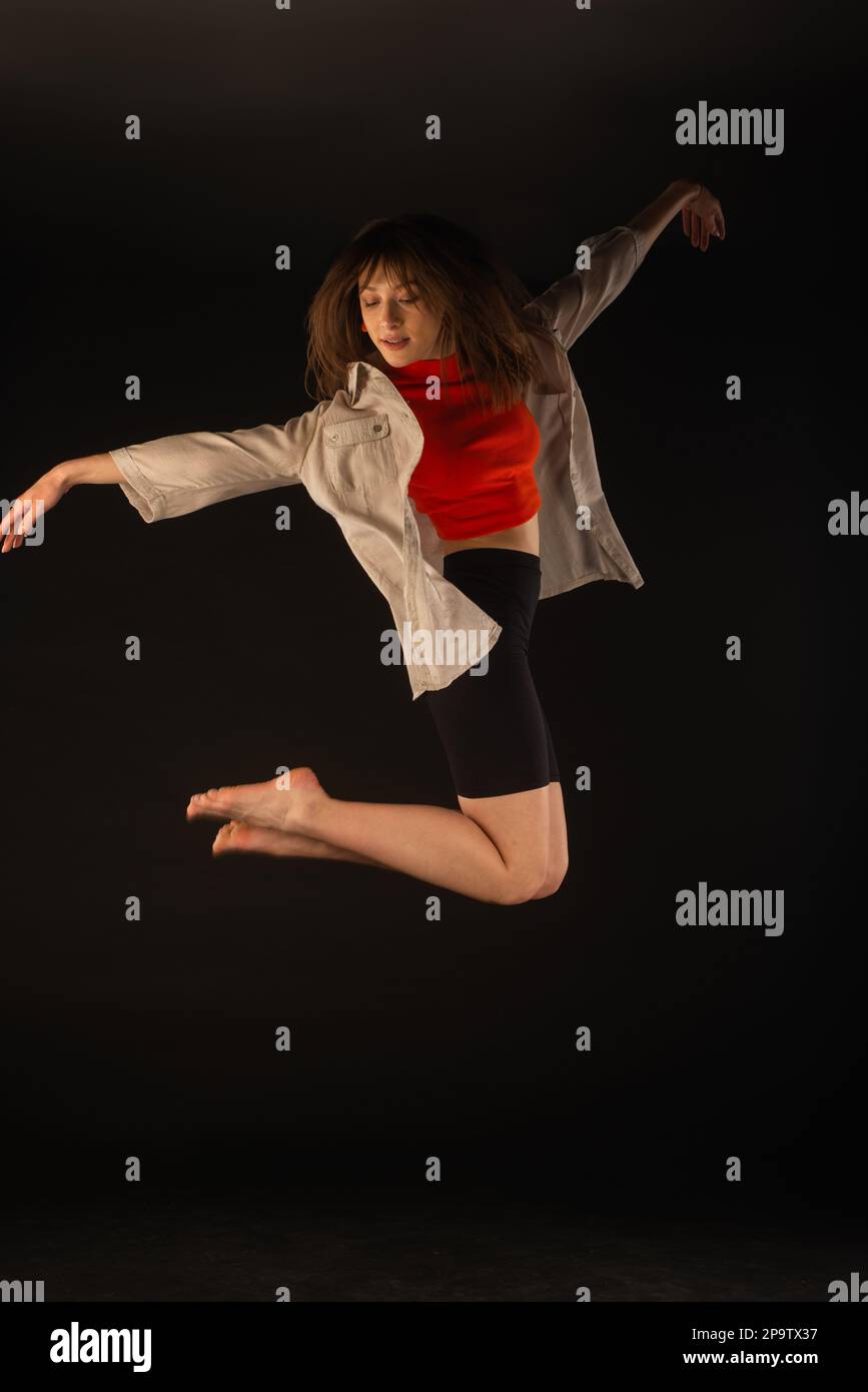 Ballerina is doing a elegant ballet jump while posing in the air Stock ...