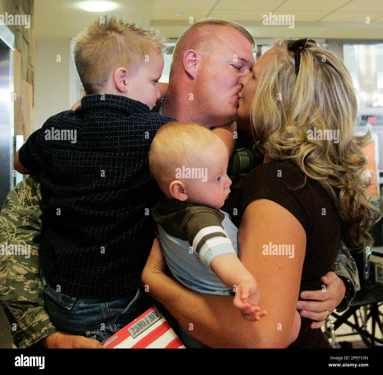 Sr. Master Sgt. Jason Garner, center at rear, holds his son, Koehn, age ...