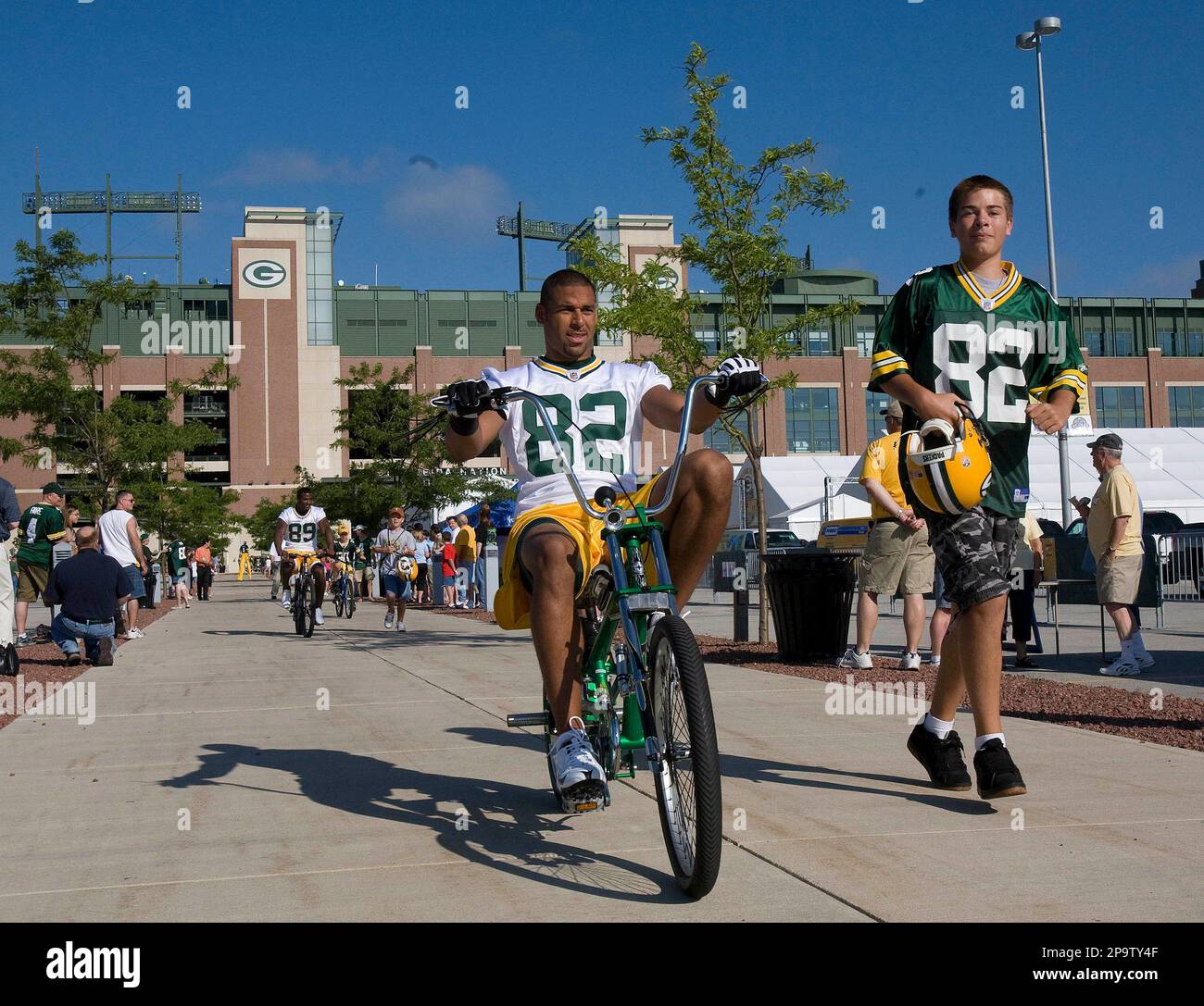Green Bay Packers' Ruvell Martin (82) rides a bike to football training ...
