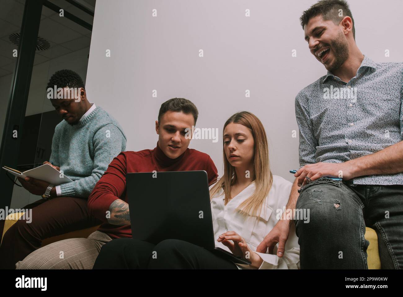 Handsome male person is joking with his colleagues while they are ...