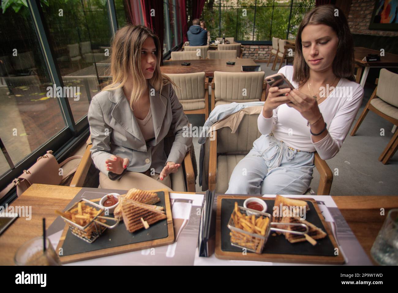 Amazing girl is hiding something on the phone from her sister Stock ...