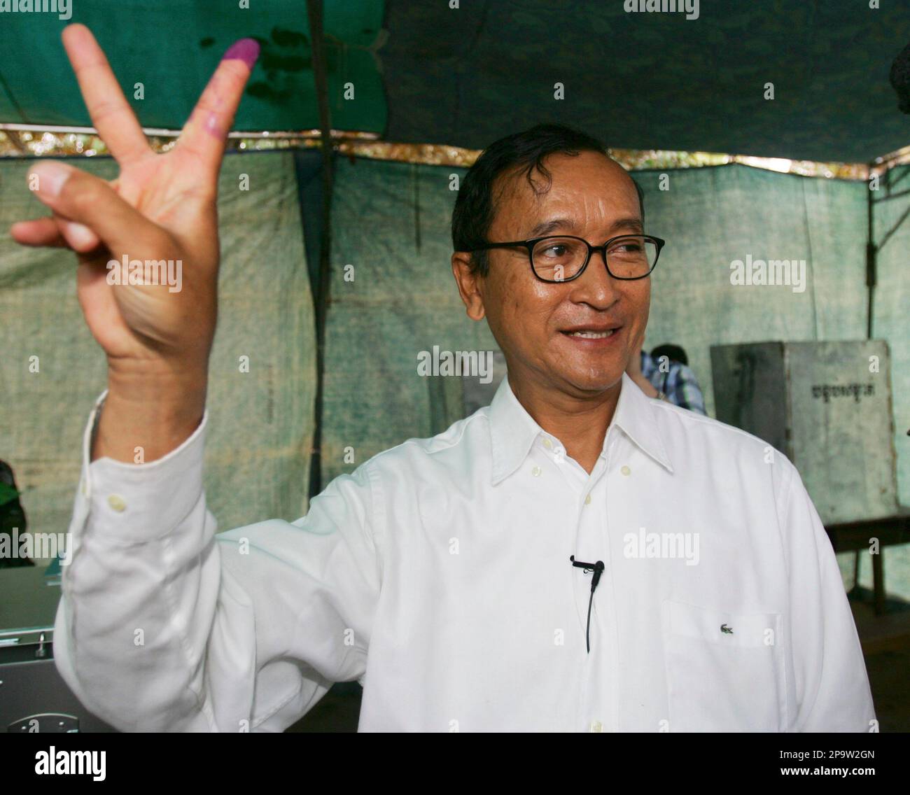Sam Rainsy, leader of Sam Rainsy Party, shows a v-sigh after casting ...