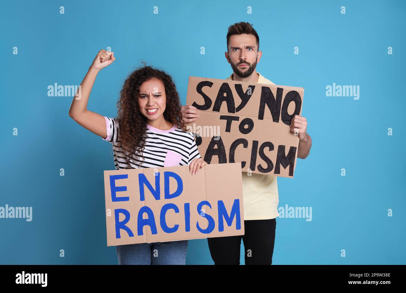 Protesters demonstrating different anti racism slogans on light blue ...