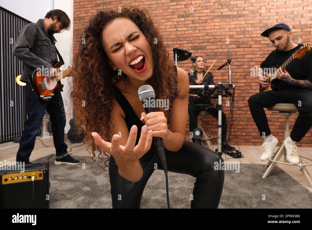 Music band performing in modern recording studio Stock Photo - Alamy