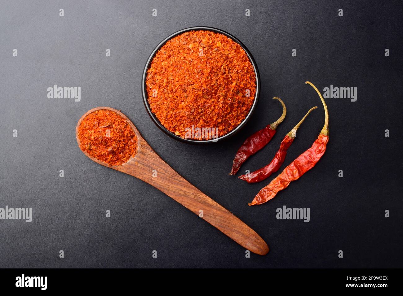 Ground red chilli in bowl and spoon Stock Photo - Alamy
