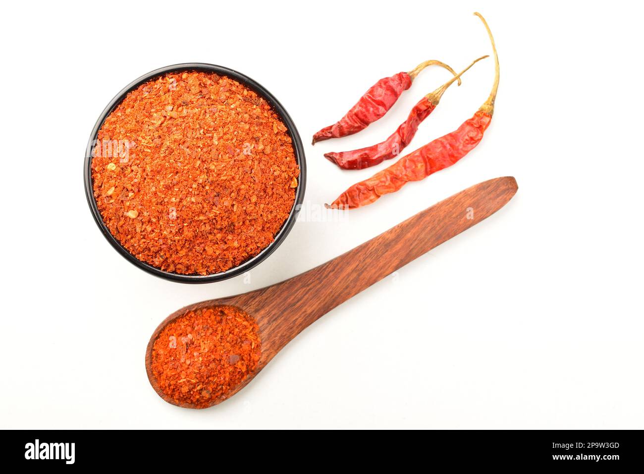 Top view of red chilli powder with dry cayenne chillies isolated on ...