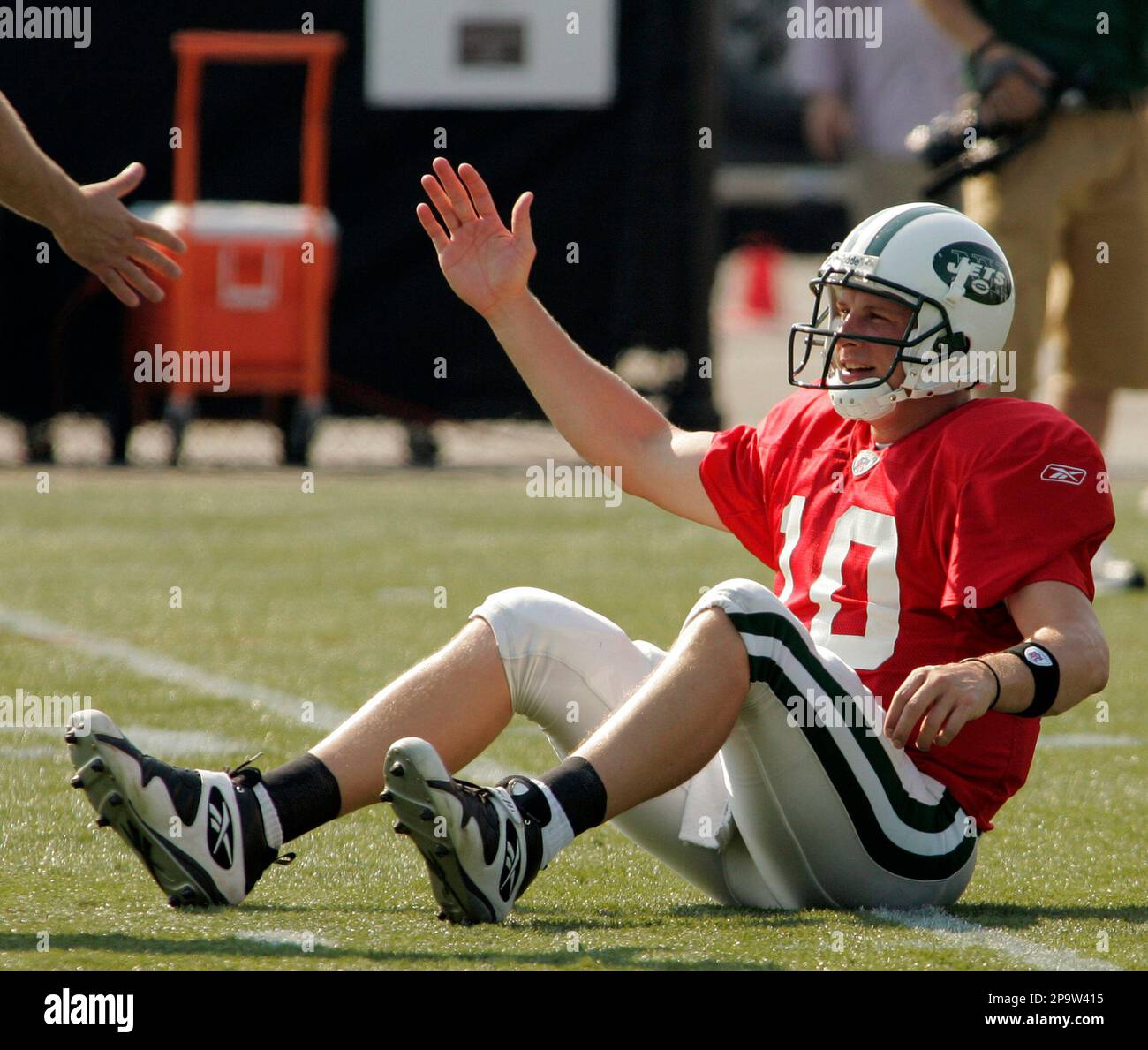New York Jets' Chad Pennington reaches for a hand to help him up during ...