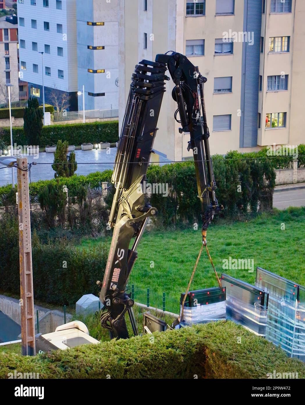 Glass panels being delivered to the flat roof of a block of flats by a ...