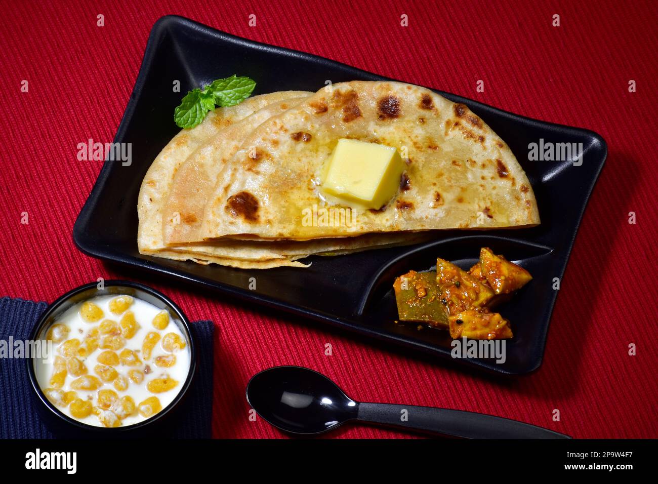Butter aloo paratha with raita and mango pickle in plate Stock Photo ...