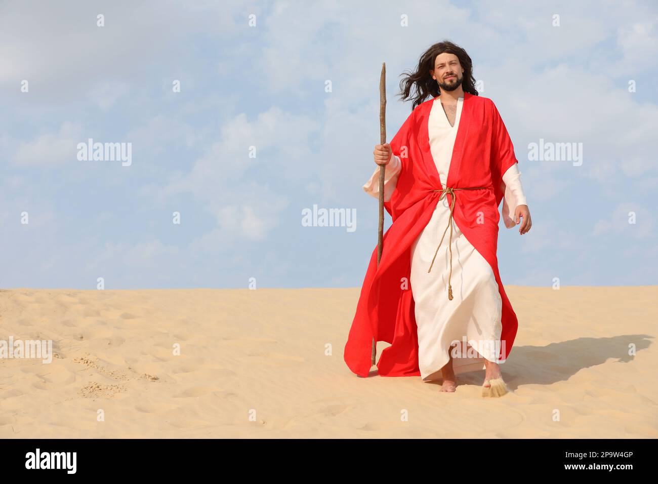 Jesus Christ walking with stick in desert. Space for text Stock Photo ...