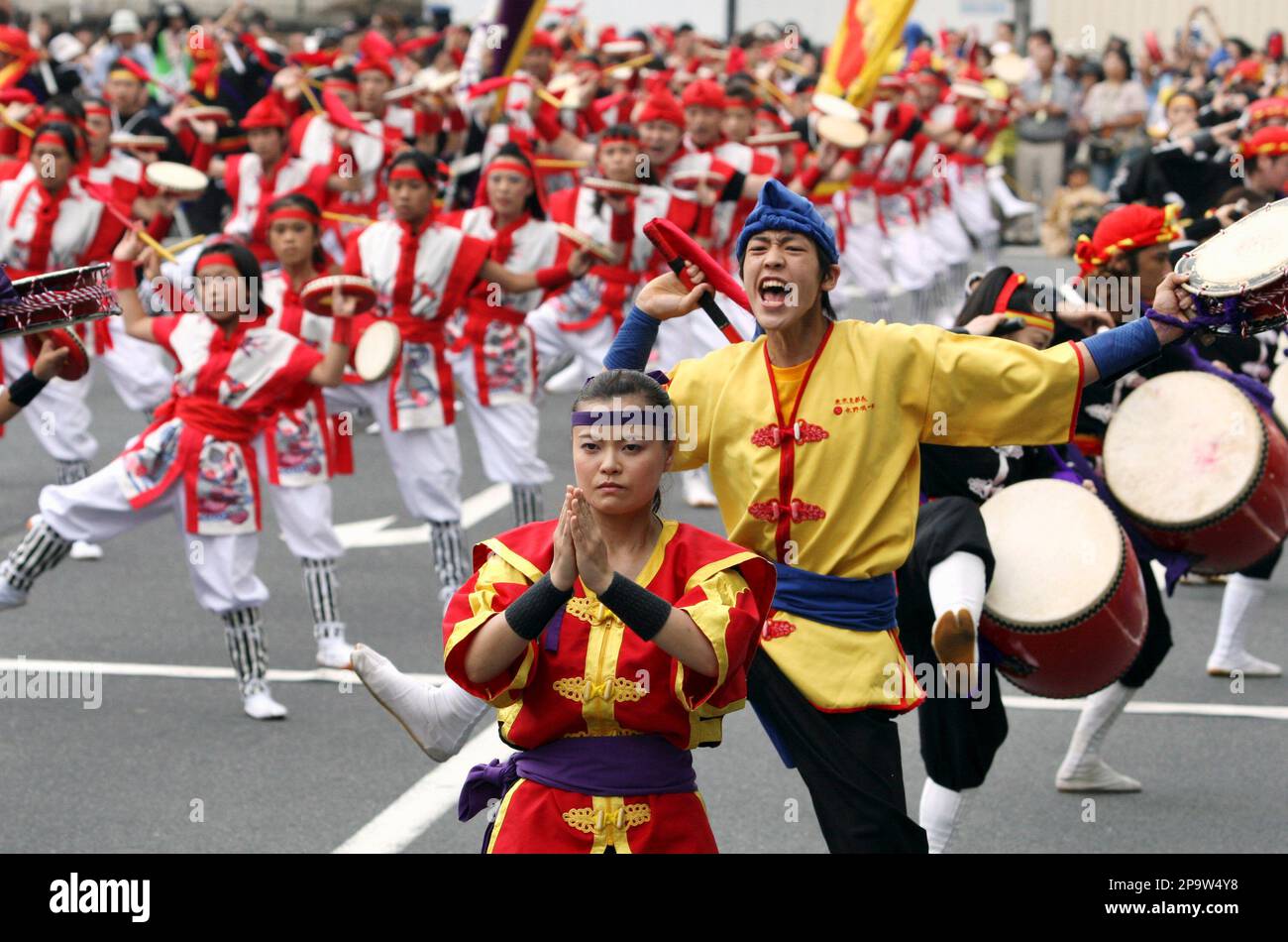Performers, wearing traditional costume of southern Japanese island of ...