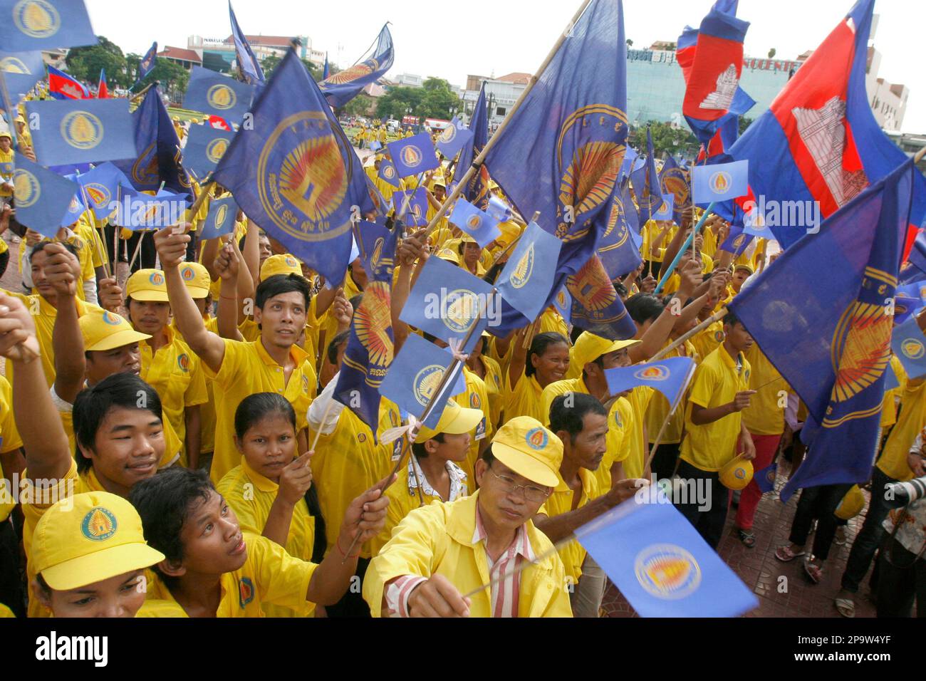 Supporters of royalist party Funcinpec hold party flags along with ...