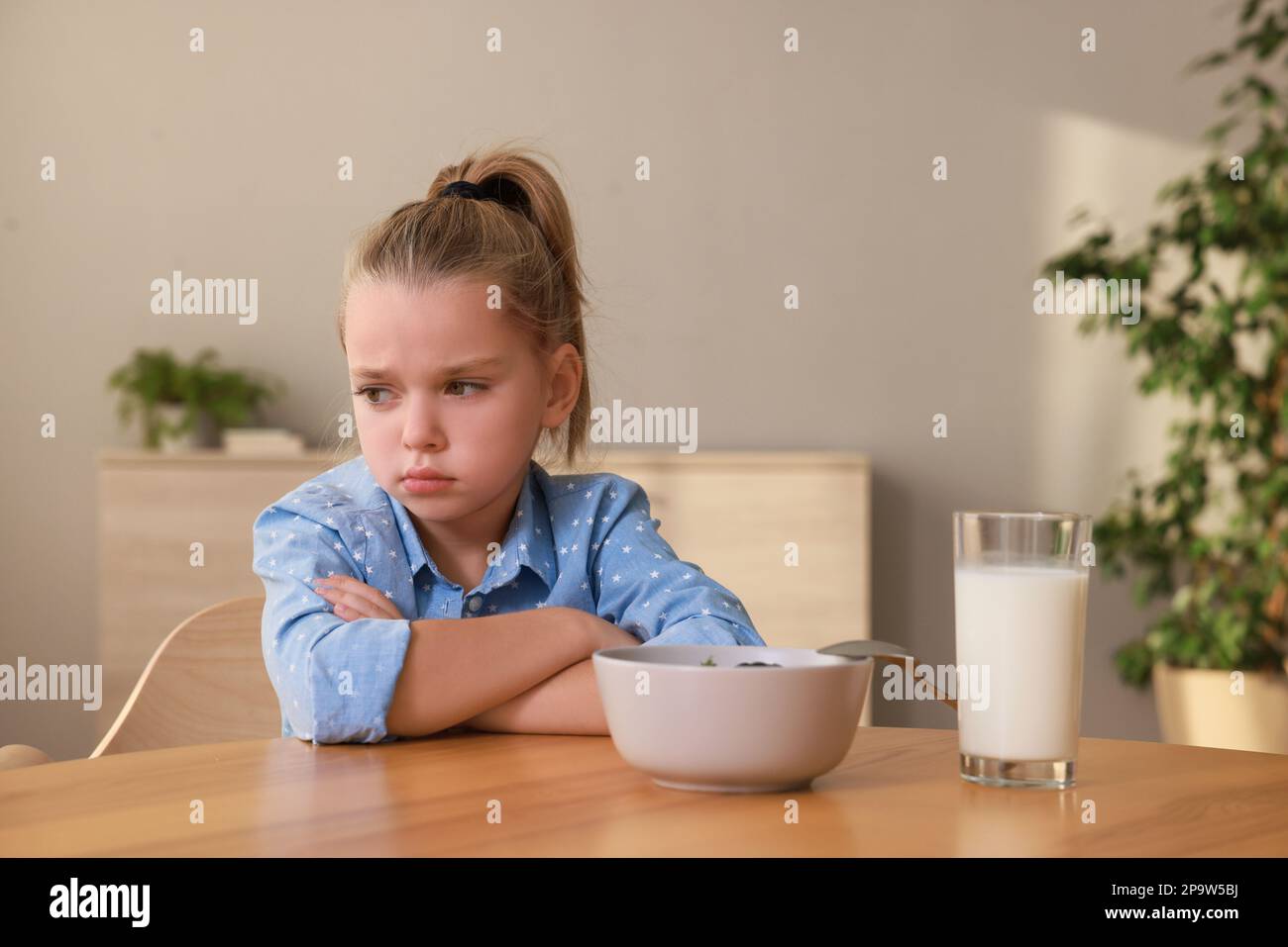 Cute little girl refusing to eat her breakfast at home Stock Photo - Alamy