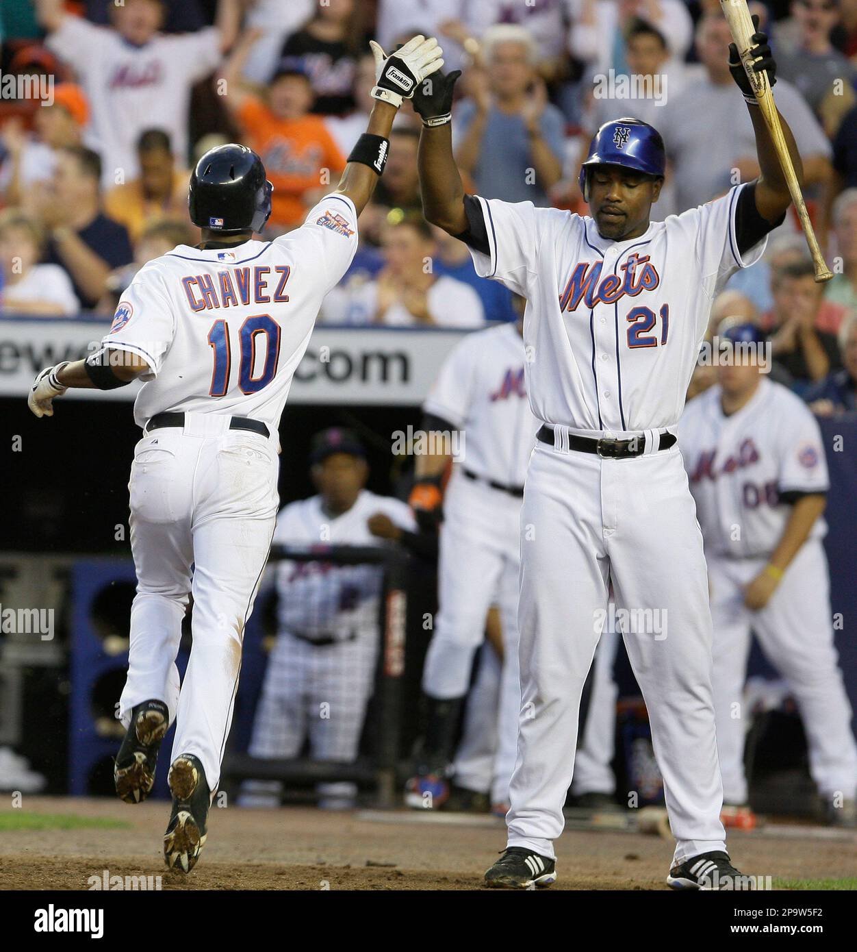 New York Mets' Endy Chavez, left, is greeted at home plate by Carlos ...
