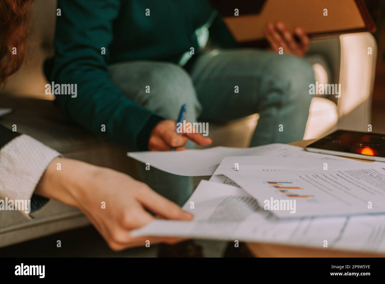 A close up photo of two business people, male and female, taking stats ...