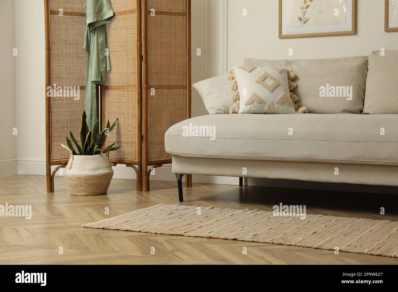 Stylish living room with folding screen and sofa. Interior design Stock ...