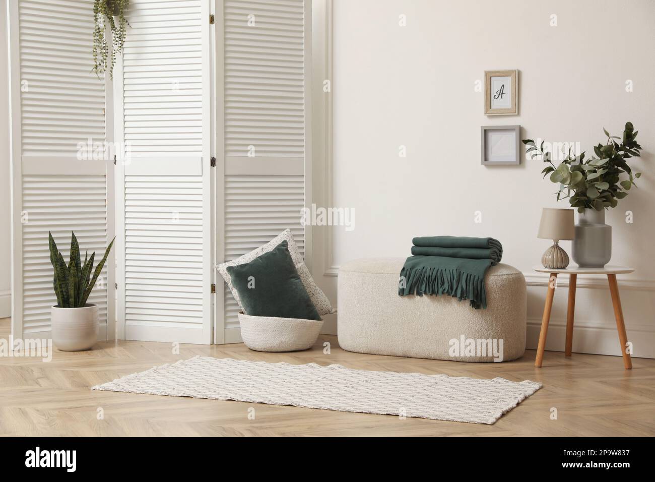 Stylish room with folding screen and furniture. Interior design Stock ...