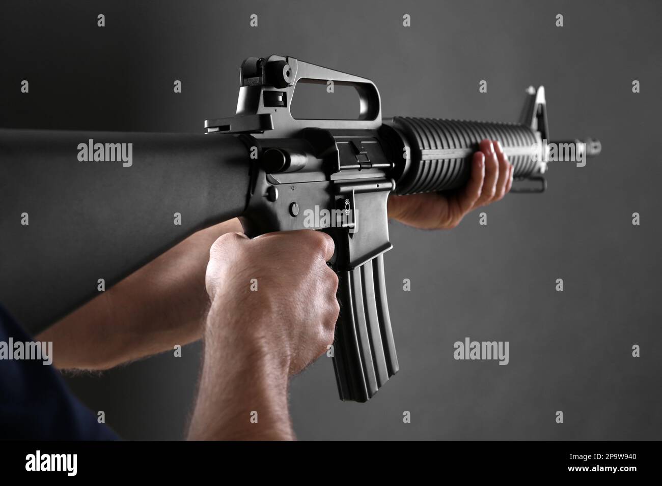 Assault gun. Man aiming rifle on dark background, closeup Stock Photo ...