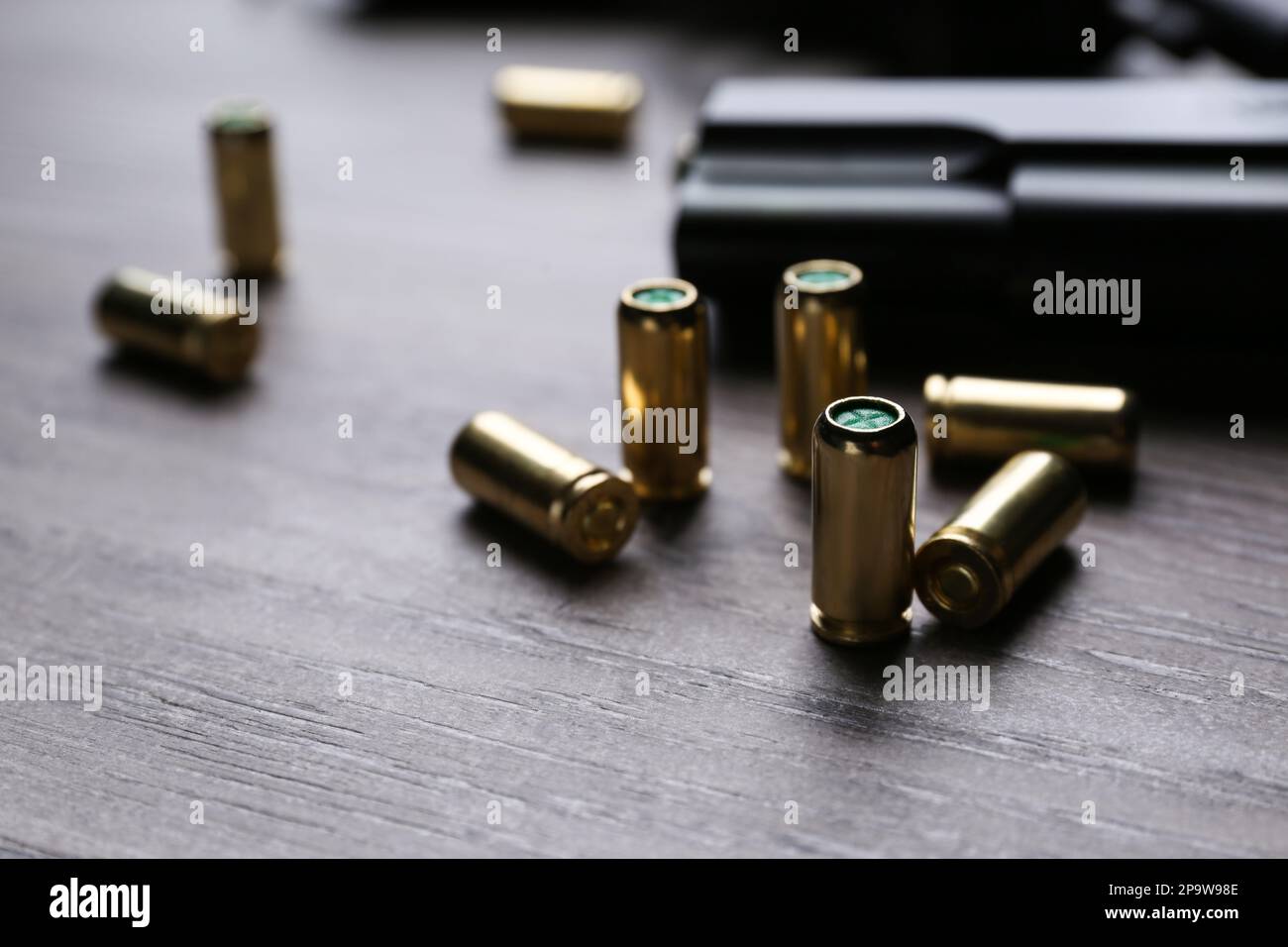 Pistol bullets on wooden table, closeup. Professional gun Stock Photo ...