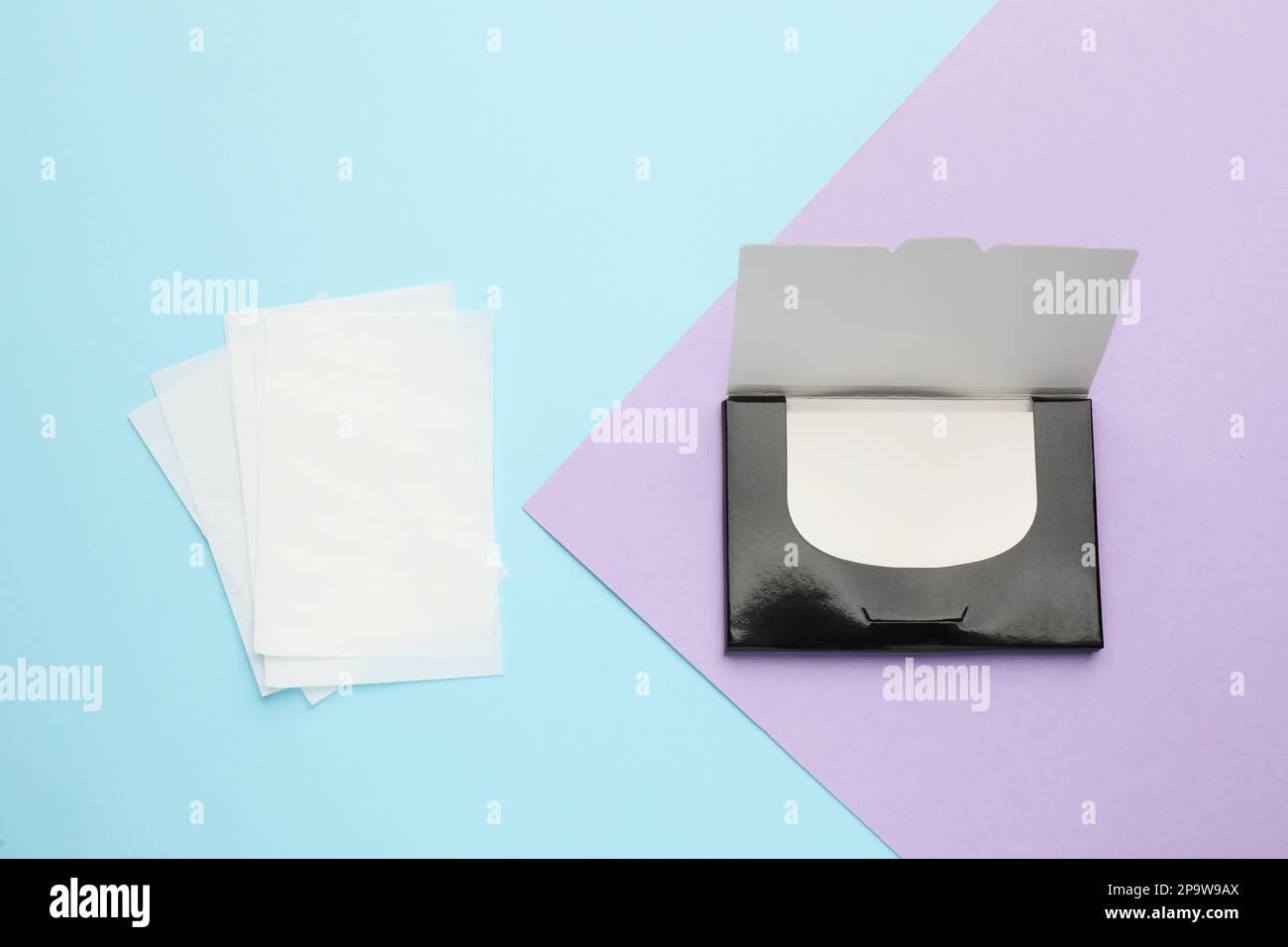 Package with facial oil blotting tissues on color background, flat lay ...