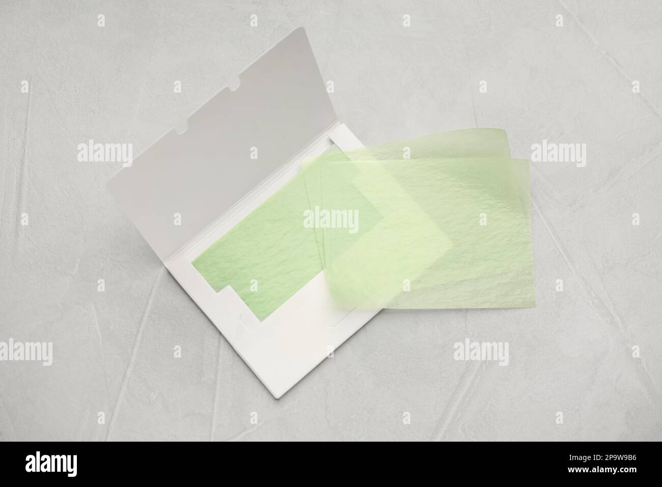 Facial oil blotting tissues on light grey background, flat lay ...