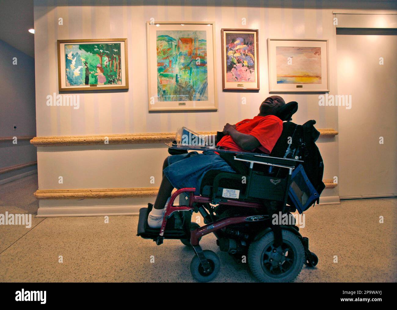 Bennie Merchant, 41, rolls down a hallway in his wheelchair Wednesday ...