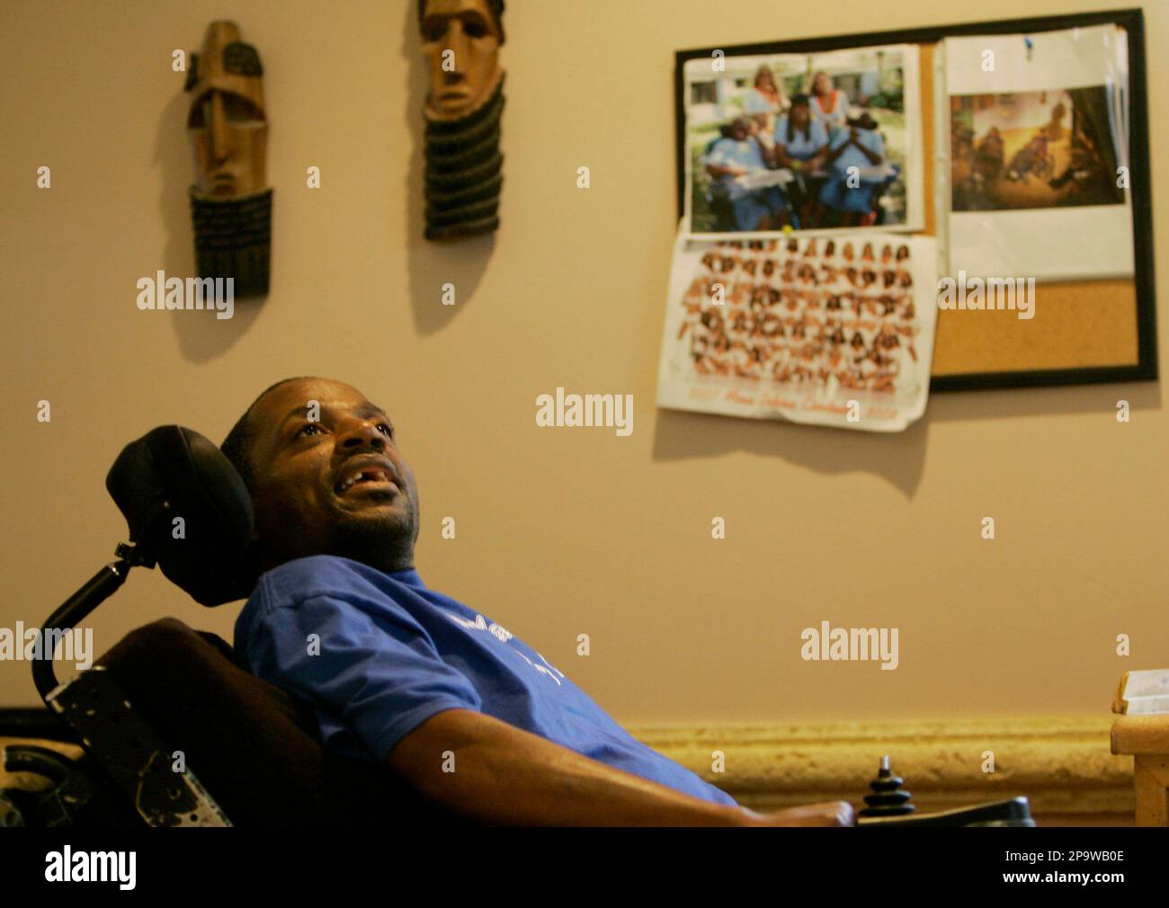 Lennie Merchant, 41, sits in his wheelchair at his desk in his room ...
