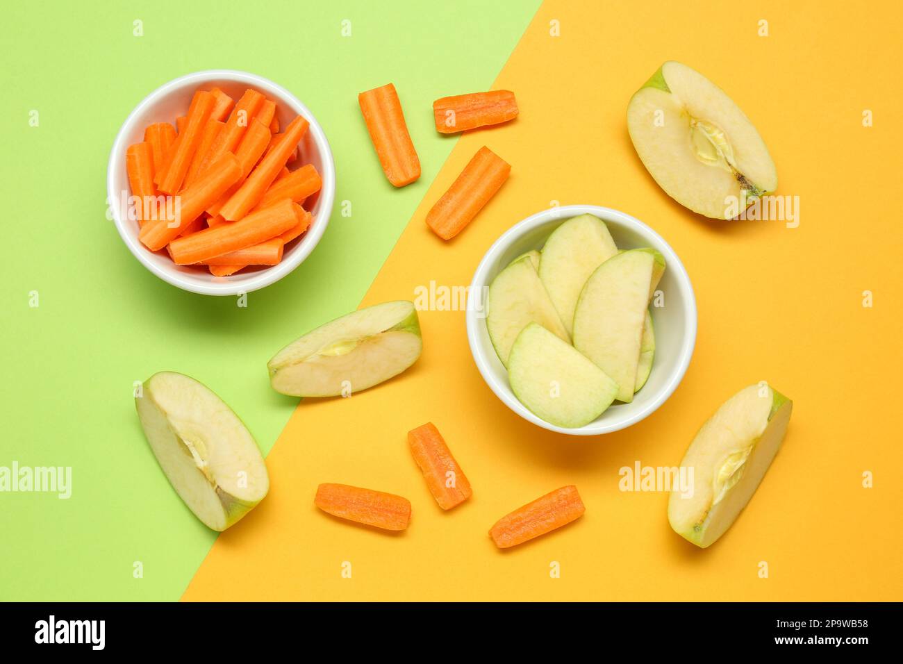 Fresh sliced carrot and apple on color background, flat lay. Finger ...