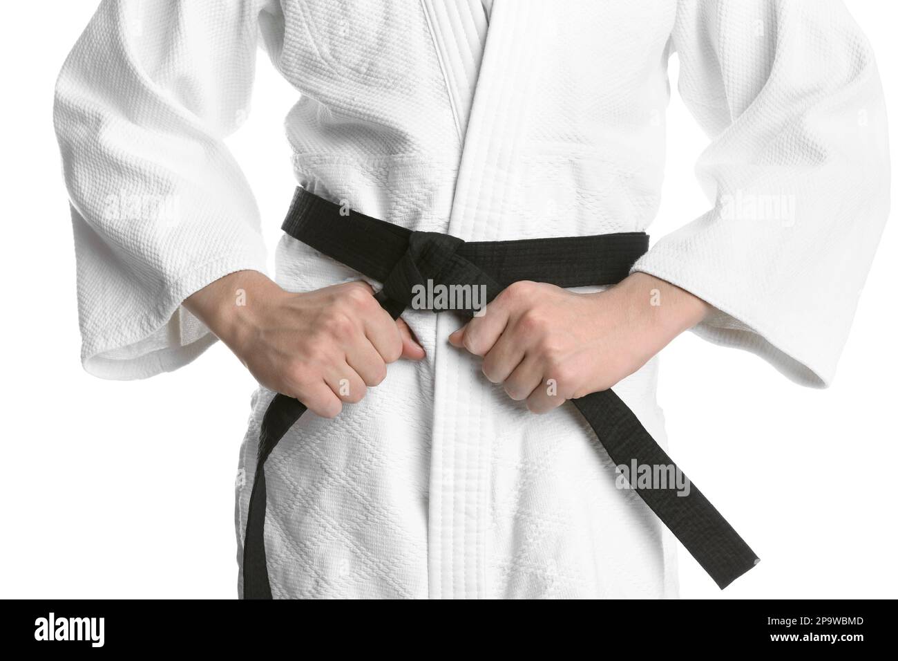 Karate coach wearing kimono and black belt on white background, closeup ...