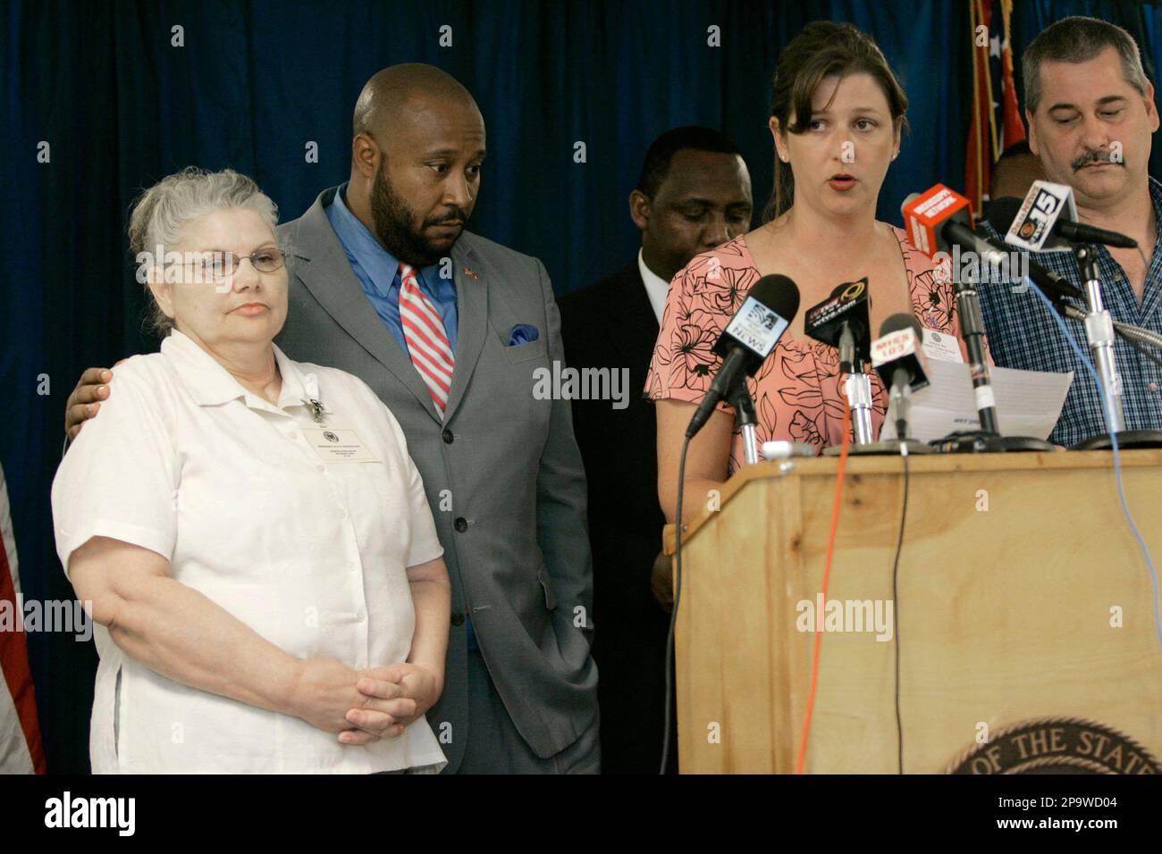 Flanked by Kathy Gentry, mother of Marcus James Gentry, left, C. Daryl ...