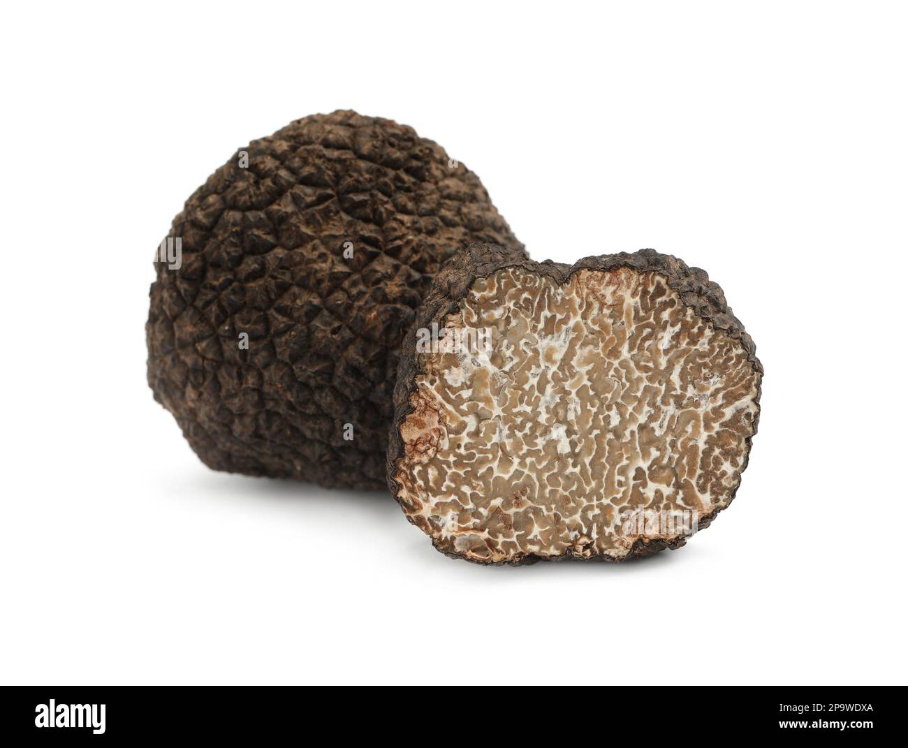Cut and whole black truffles isolated on white Stock Photo - Alamy