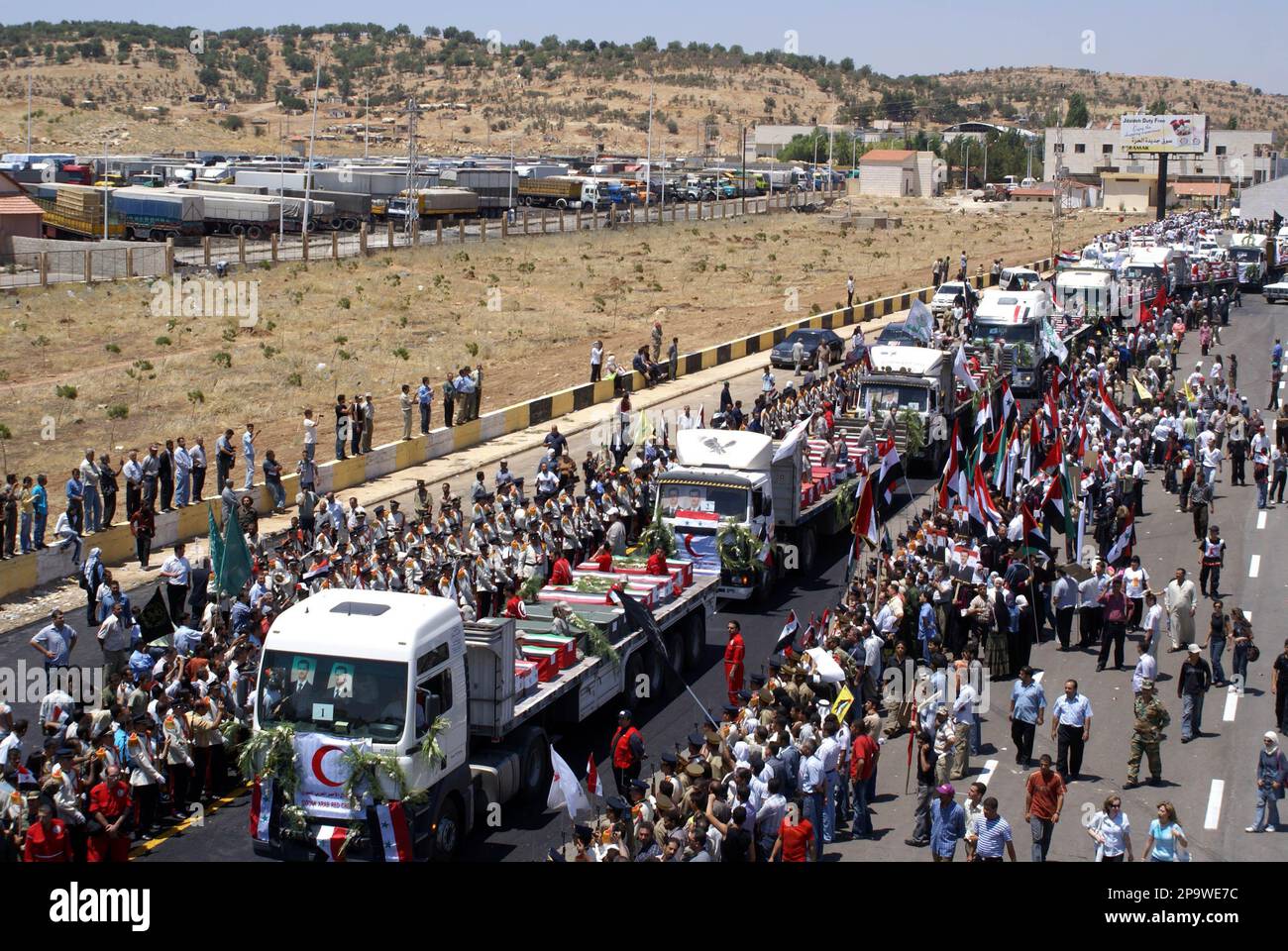 Syrian and Palestinians welcome a convoy of trucks carrying the bodies ...