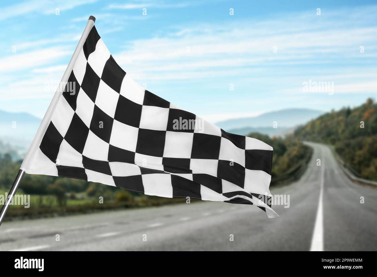 Checkered racing finish flag and asphalt road outdoors Stock Photo - Alamy