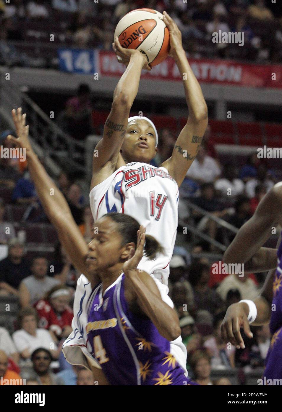 Detroit Shock's Deanna Nolan (14) takes a shot over Los Angeles Sparks' Kiesha Brown during the ...