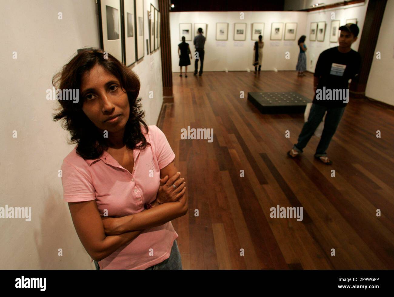 Anoma Rajakaruna, left, stands inside a gallery exhibiting her body of ...