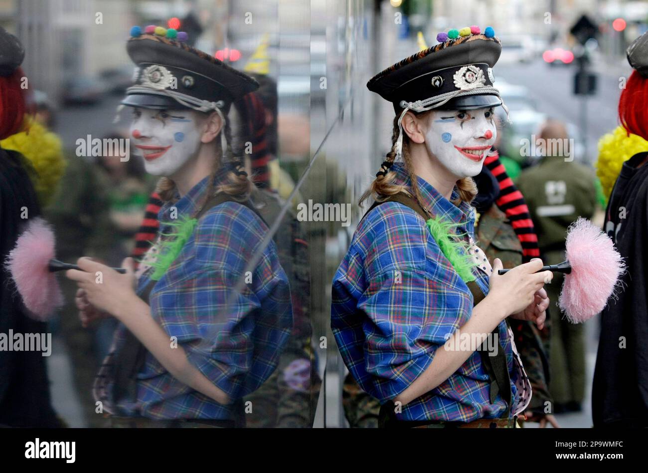 Demonstrators dressed like clowns protest against a public swearing-in ...