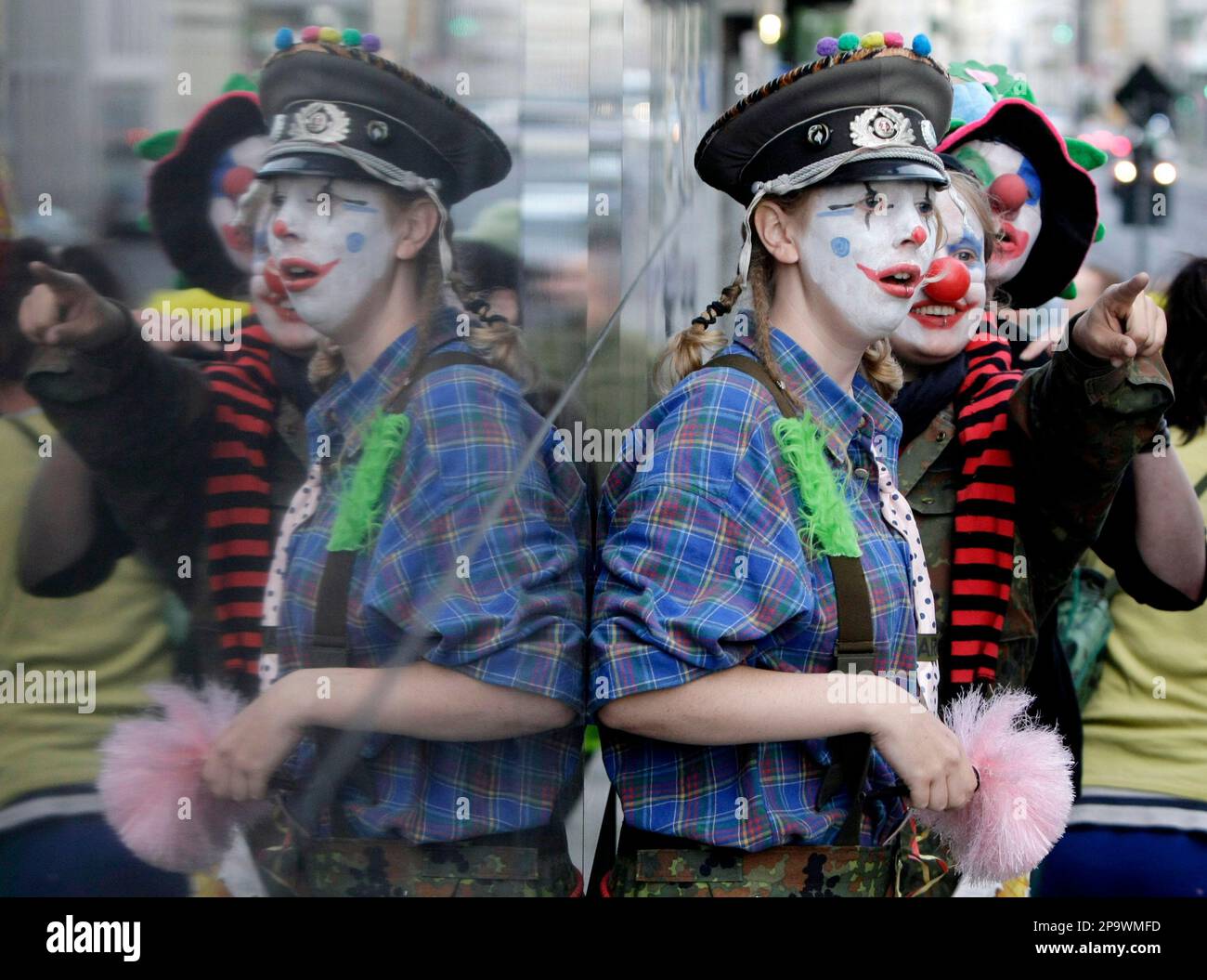 Demonstrators dressed like clowns protest against a public swearing-in ...