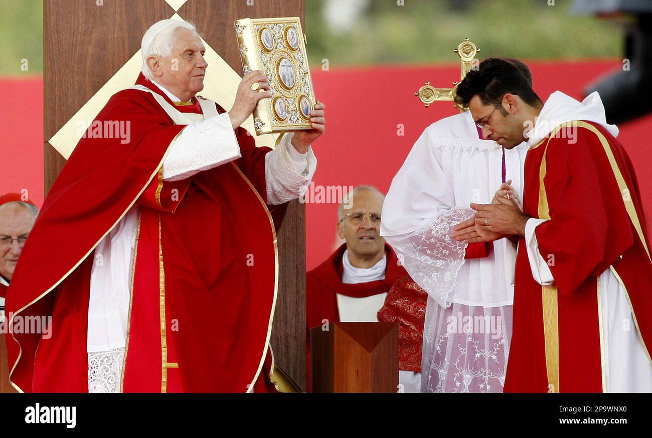 The Bible is held aloft by Pope Benedict XVI left, during the Final ...