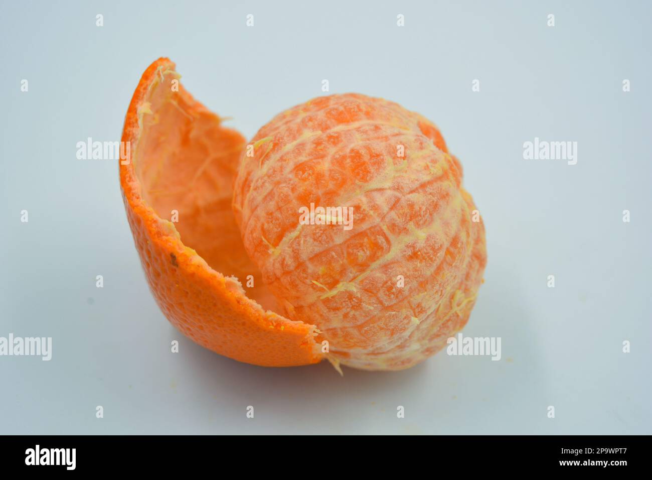 Fresh fruits, orange tangerine with a thin skin removed is located on a ...