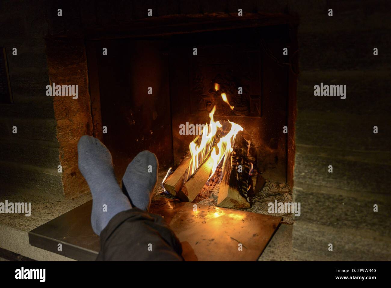 Warming in front of open fire hi-res stock photography and images - Alamy